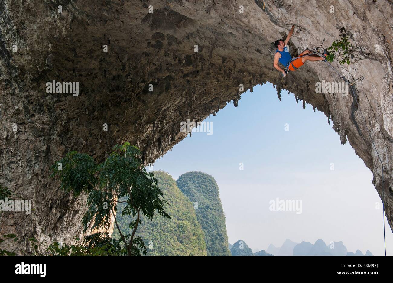 Male climber climbing the route Lunatic on Moon Hill in Yangshuo ...