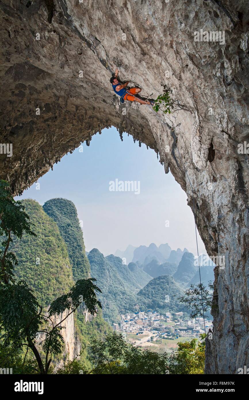 Male climber climbing the route Lunatic on Moon Hill in Yangshuo ...