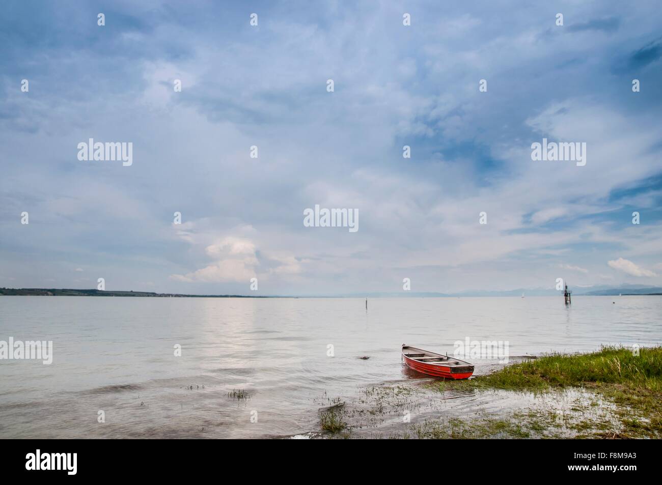 Red rowing boat at waters edge, Munich, Germany Stock Photo - Alamy