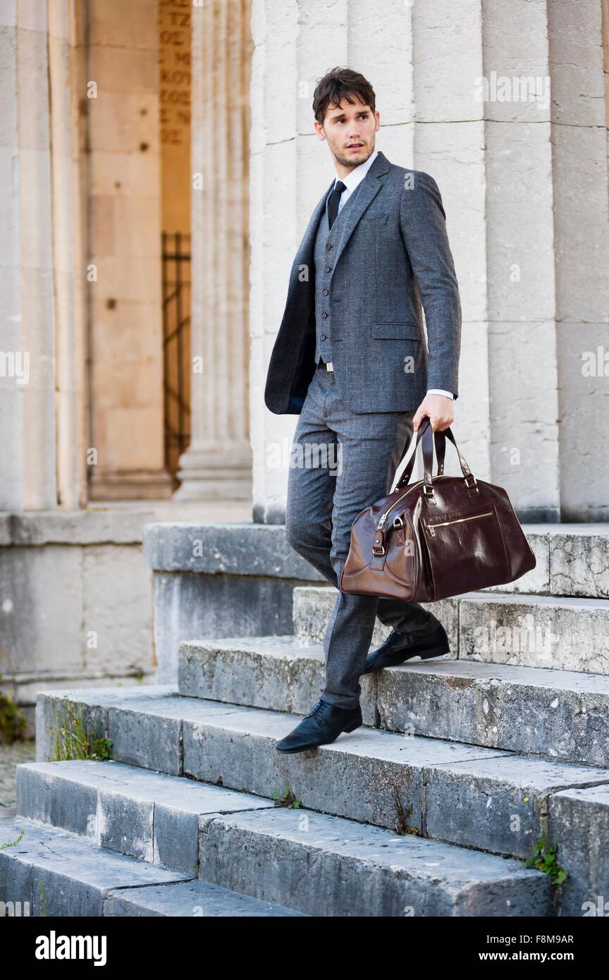 Smart man walking down steps hi-res stock photography and images - Alamy