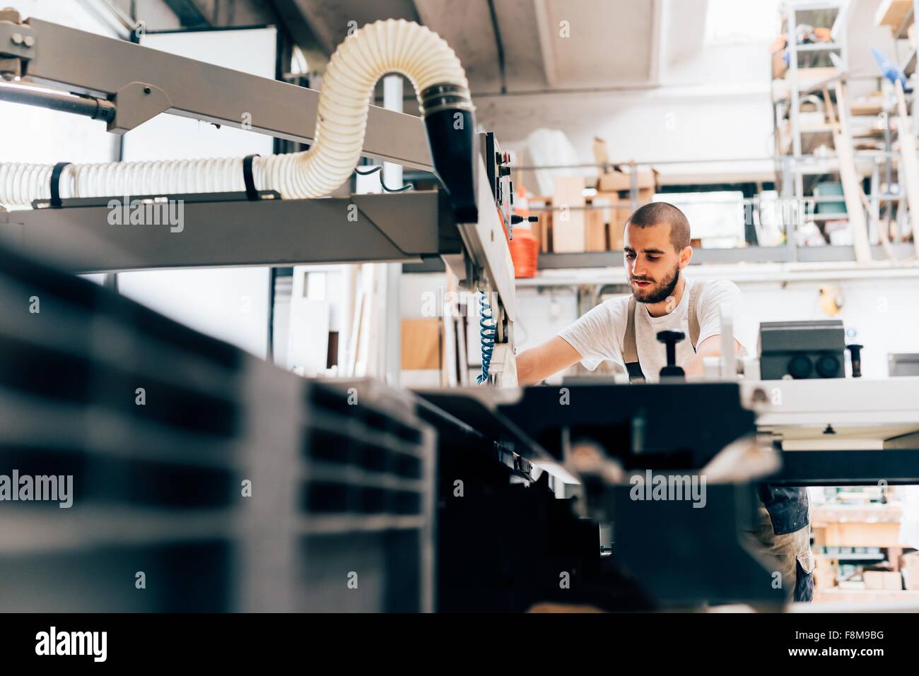 Carpenter working on machine Stock Photo - Alamy