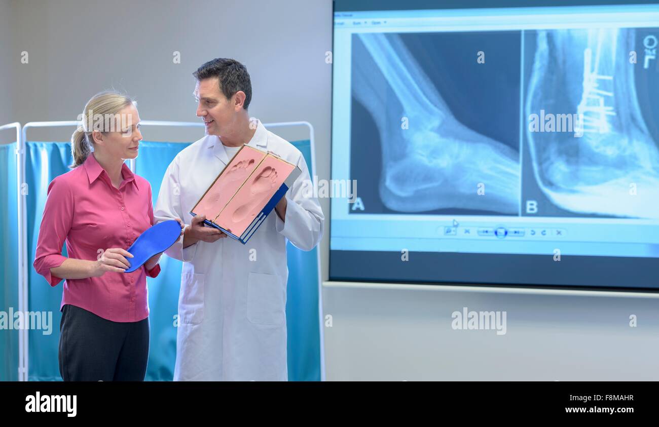 Making a foot imprint mould for orthopaedic foot support Stock Photo ...