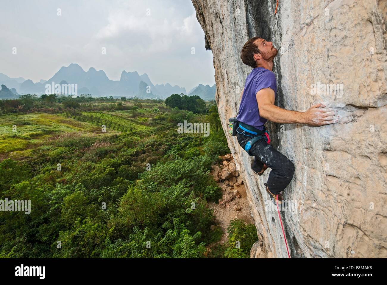 Elevated view of male climber climbing at white Mountain - a limestone ...