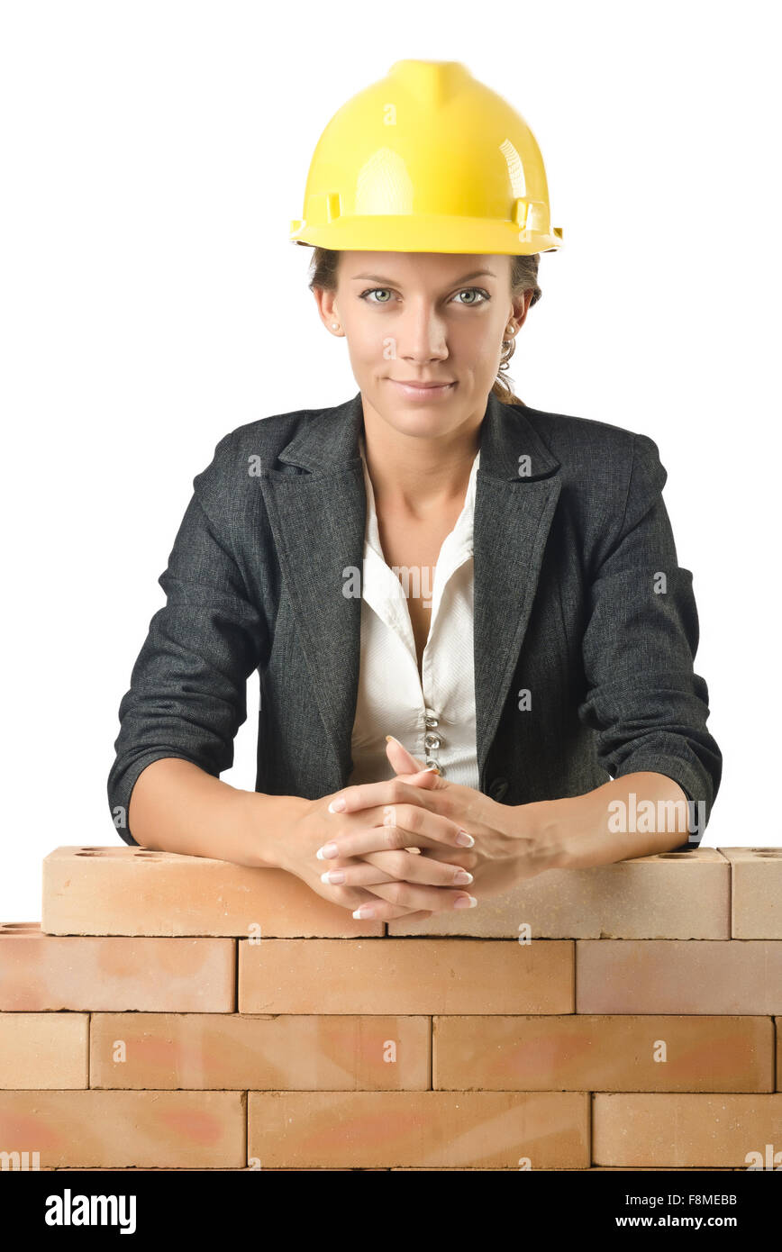 Young female builder near brick wall Stock Photo - Alamy