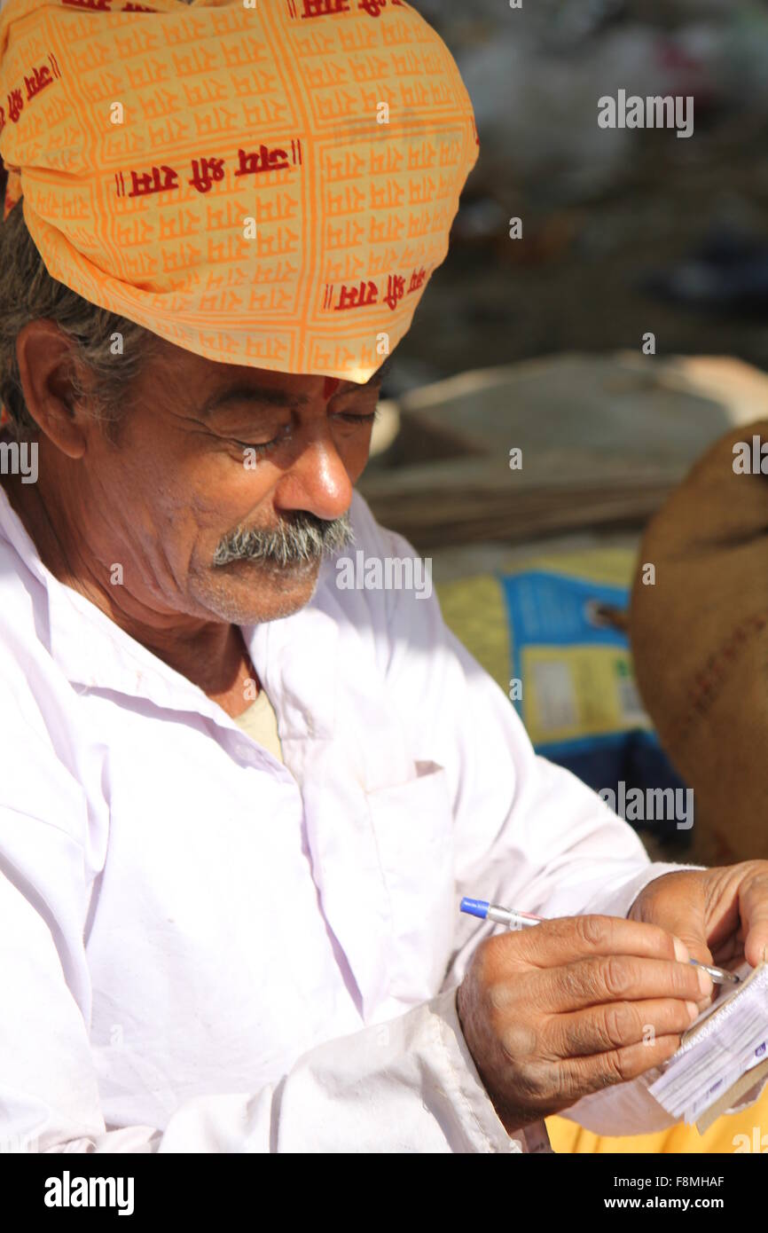 JAIPUR, INDIA - NOVEMBER 30 2012: Portrait of an Indian man with yellow ...