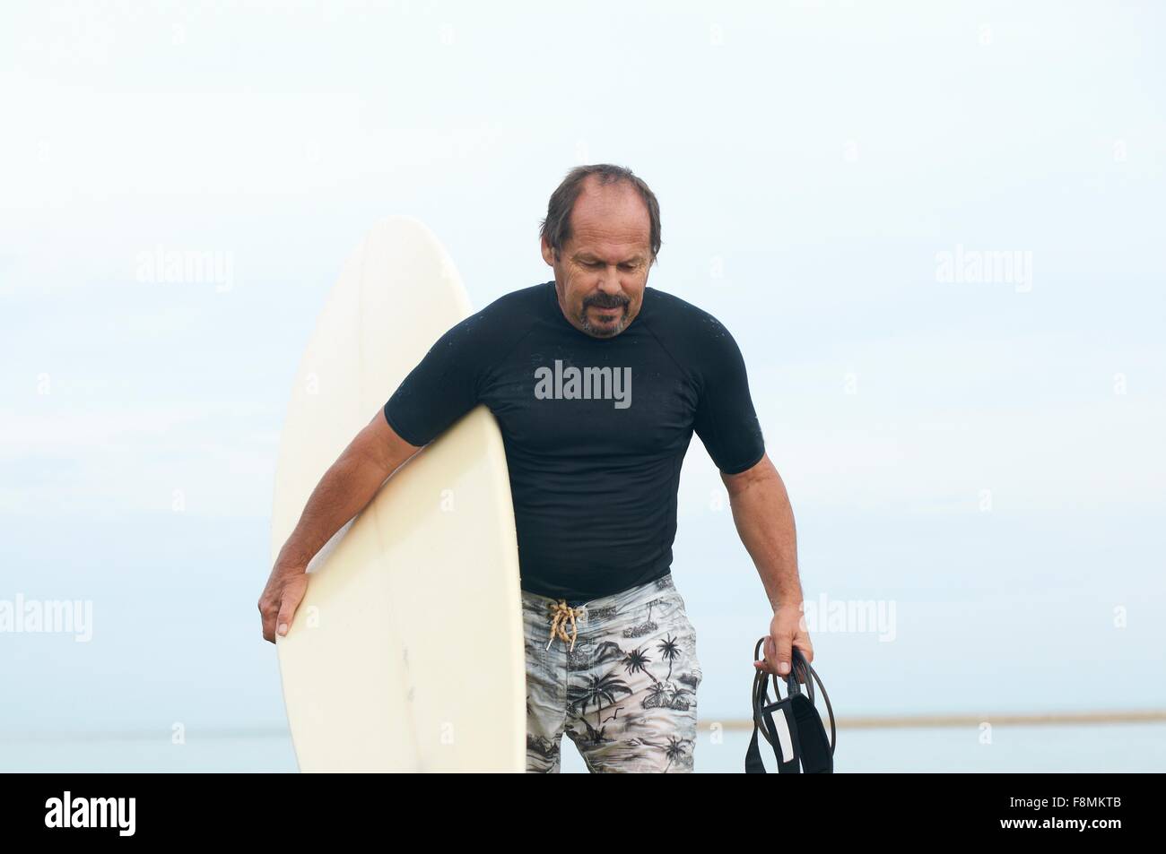 Man carrying surfboard water hi-res stock photography and images - Alamy
