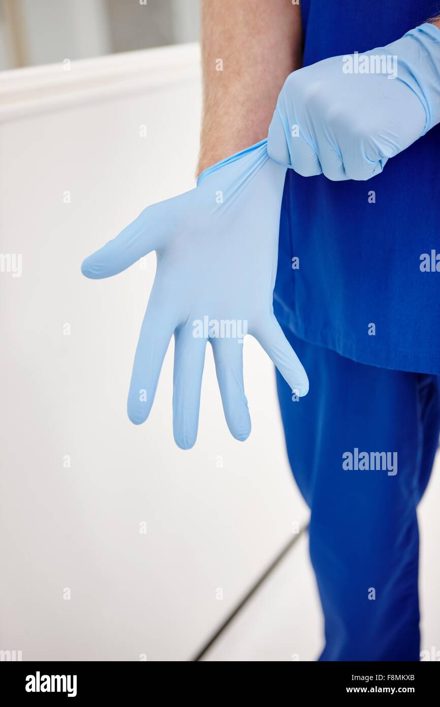 Doctor Putting On Rubber Gloves High Resolution Stock Photography and ...