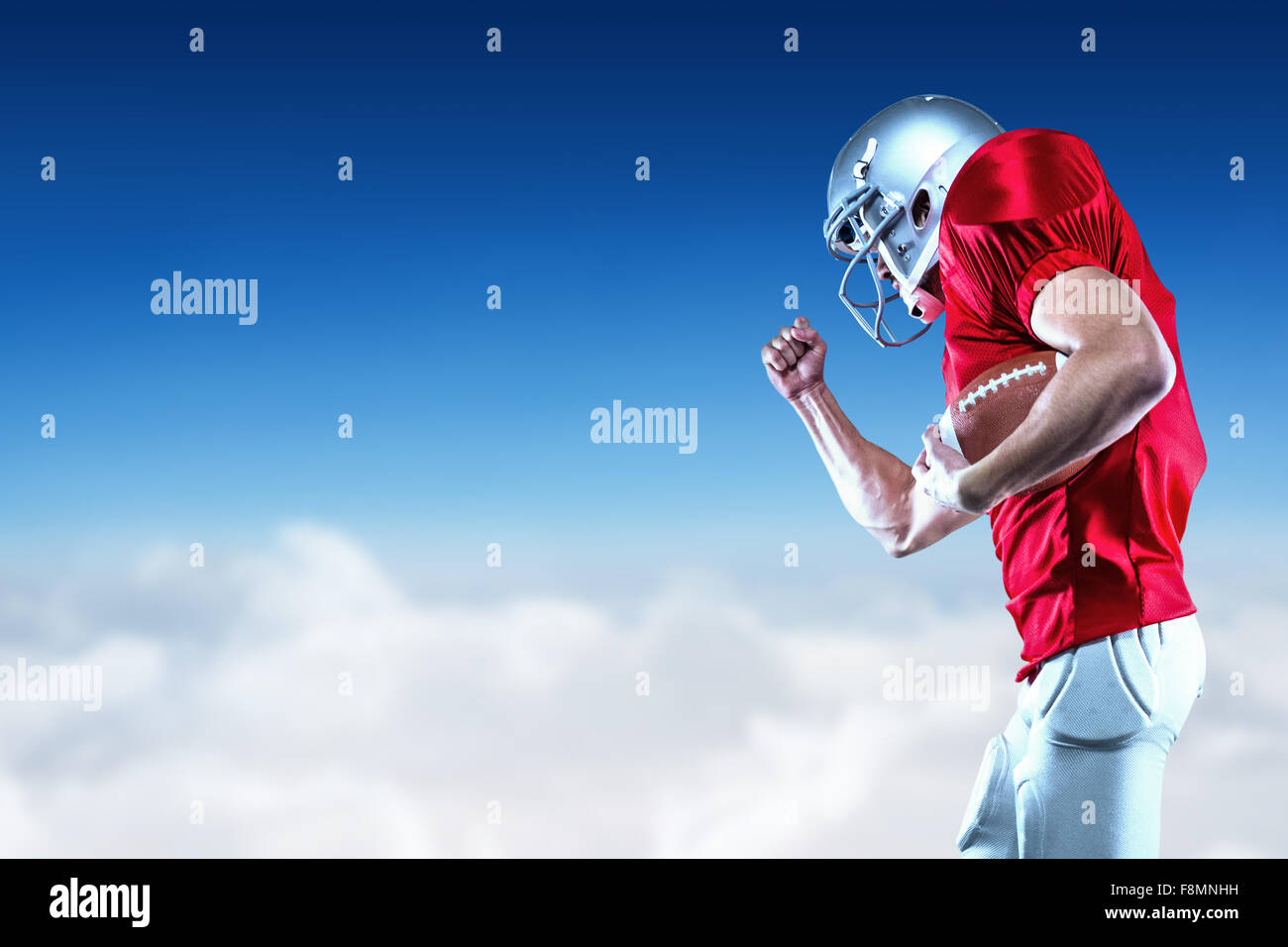 Composite image of american football player in mid-air Stock Photo - Alamy