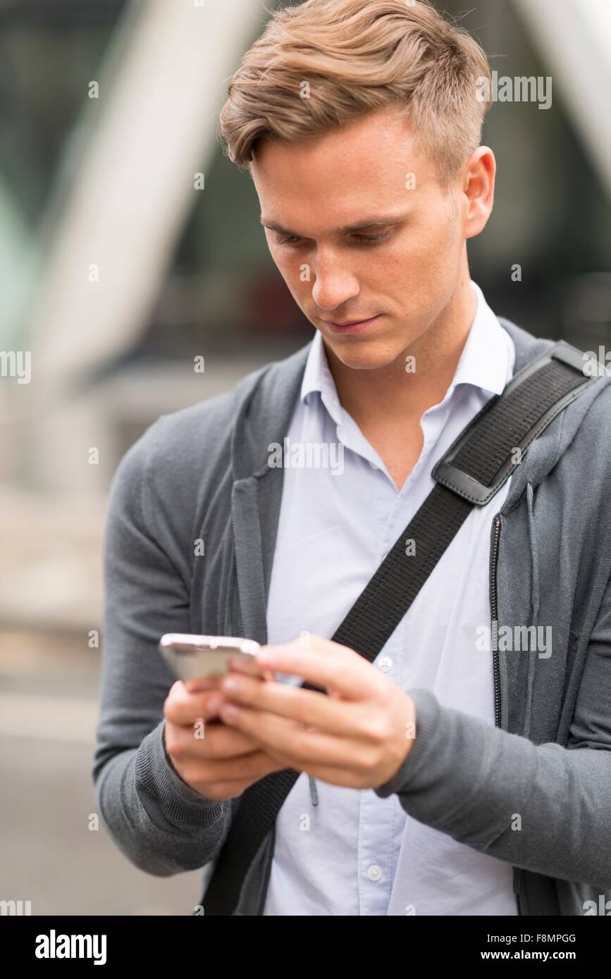 Man texting in street Stock Photo - Alamy