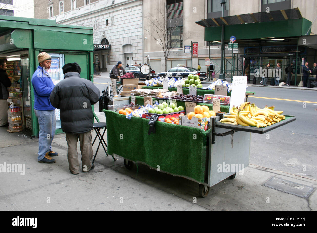 A man selling fresh fruit on the stand in the street in Midtown ...