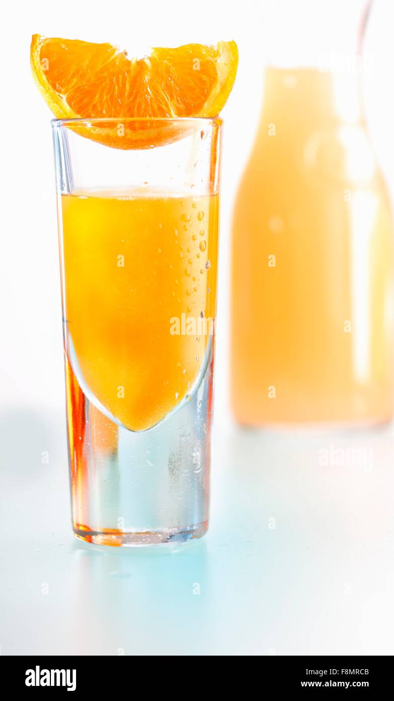 An orange juice shooter Stock Photo - Alamy