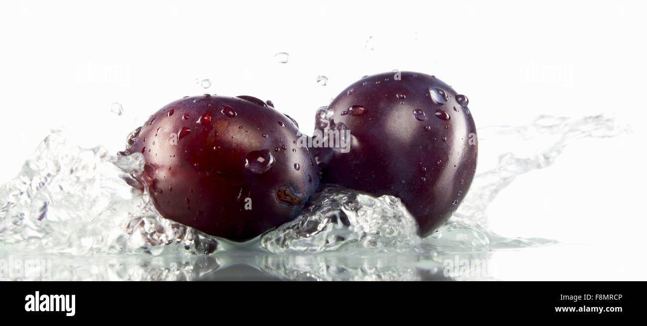 Two plums in water Stock Photo - Alamy