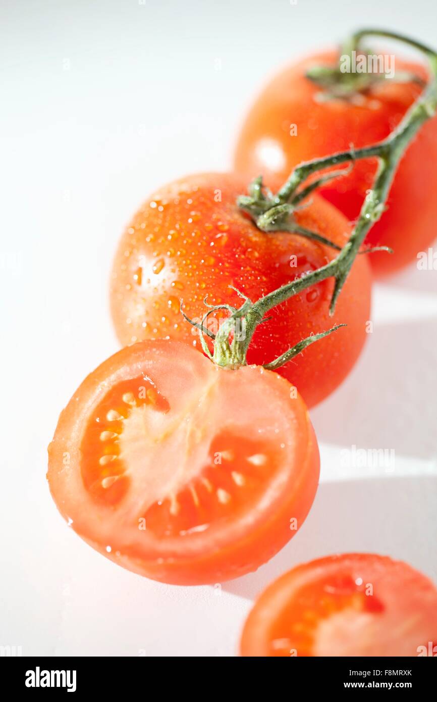 Organic Vine Ripened Tomatoes with Vine; One Halved Stock Photo - Alamy