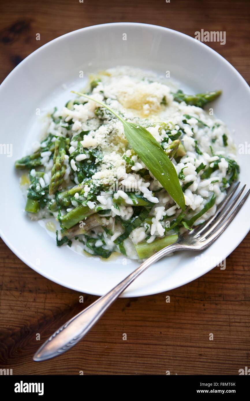 Risotto with green asparagus, ramsons and Parmesan cheese Stock Photo ...