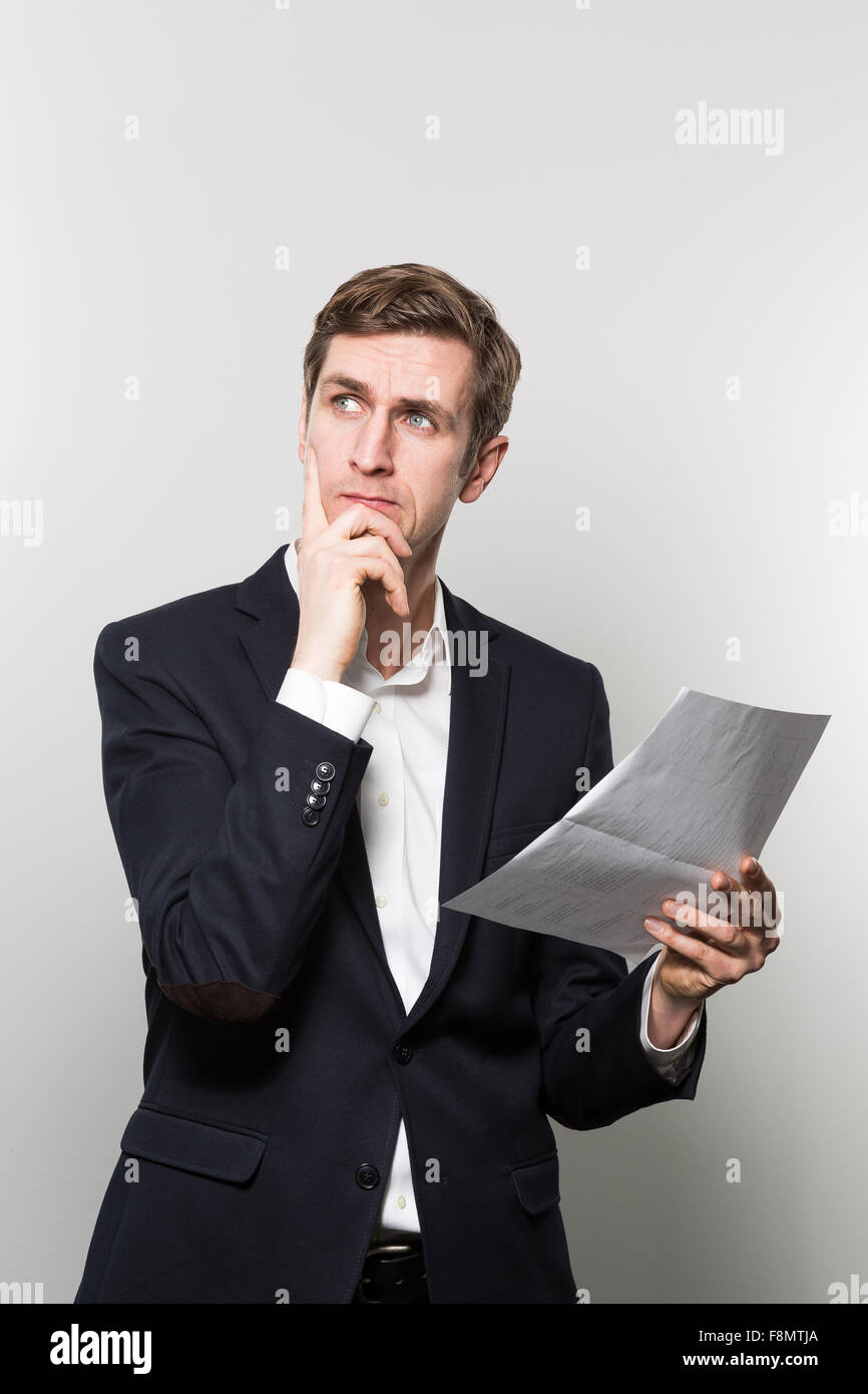 Blond-haired european businessman with a searching look stares into the ...