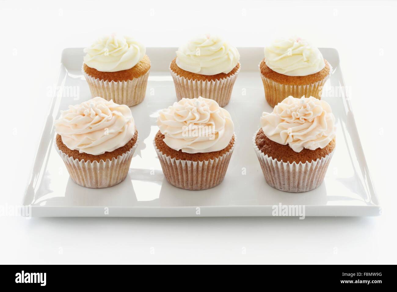 Six buttercream cupcakes on a square tray Stock Photo - Alamy