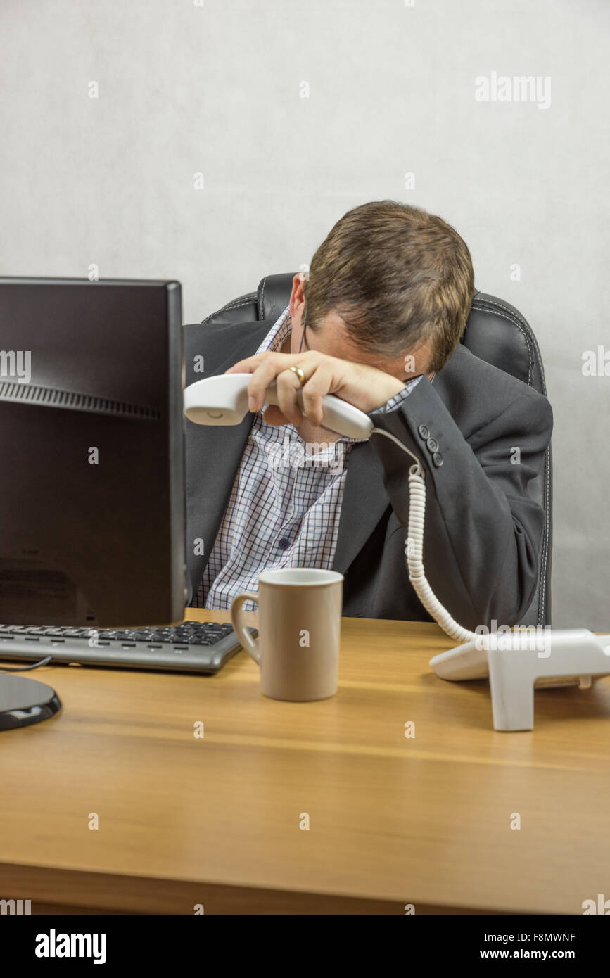 A man working at his computer in the office Stock Photo - Alamy