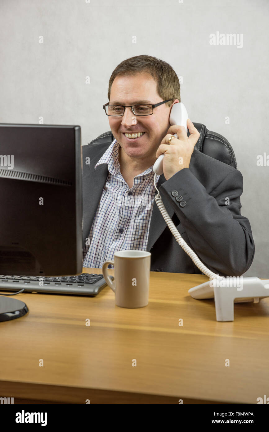 A man working at his computer in the office Stock Photo - Alamy