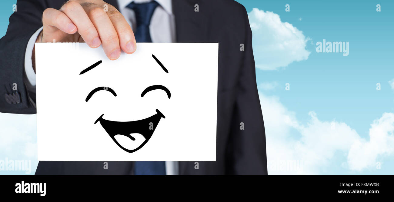 Composite image of mature businessman showing card Stock Photo - Alamy