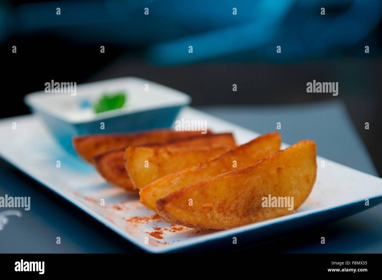 Potato wedges on a rectangular plate Stock Photo - Alamy