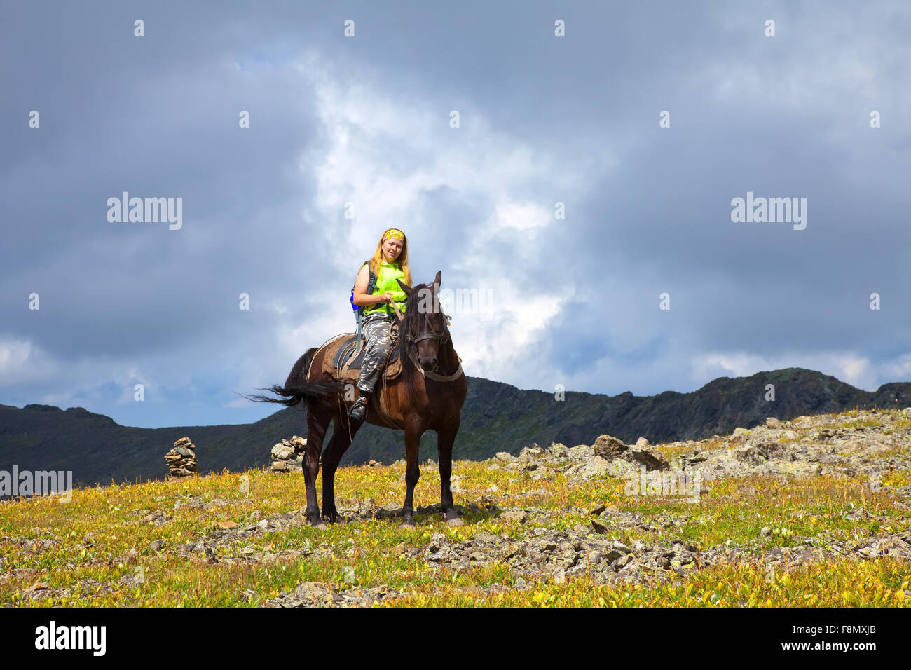 lone rider on horseback at mountains Stock Photo - Alamy