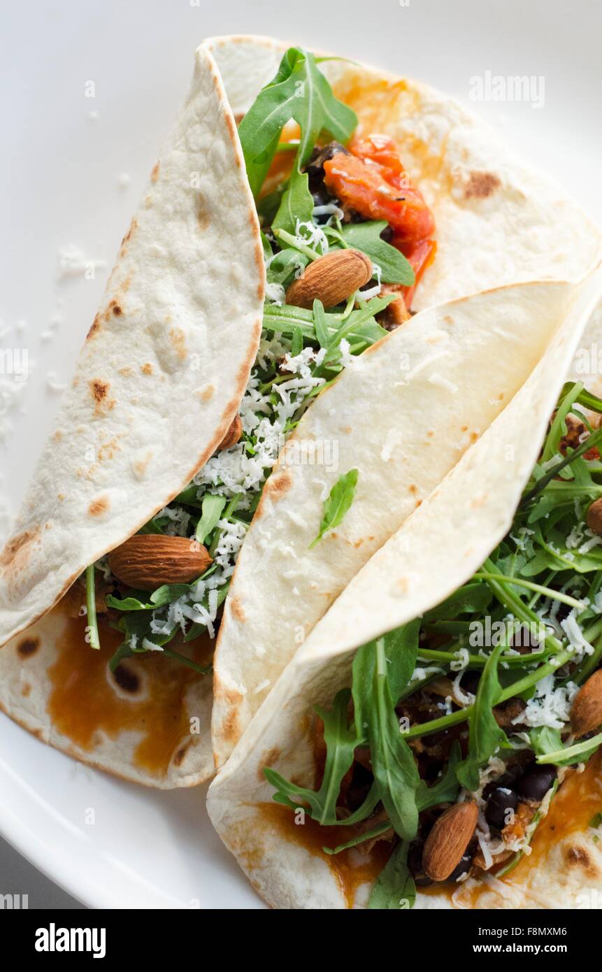 Burritos filled with rocket and almonds Stock Photo - Alamy