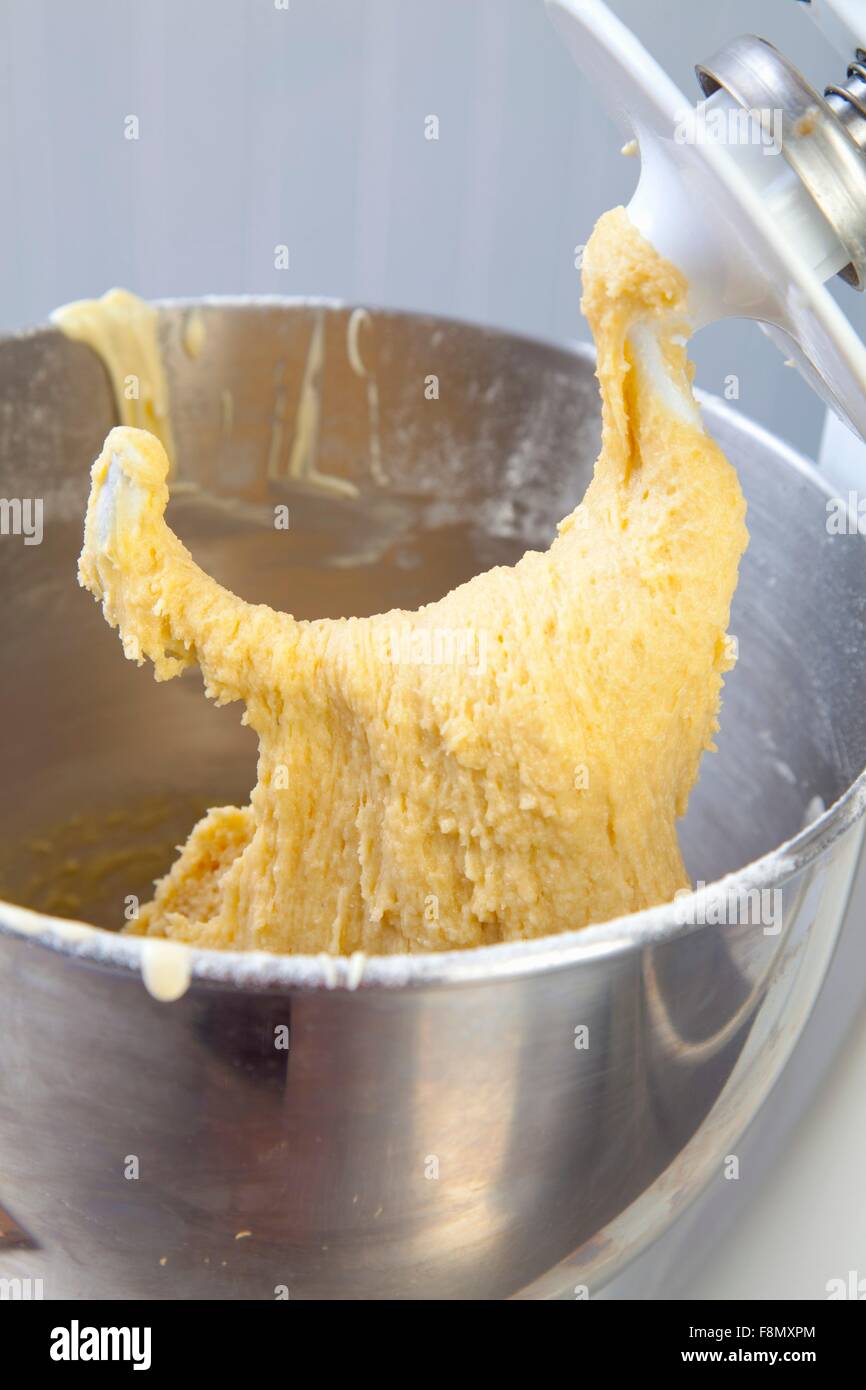 Cake batter on the dough hook of a food processor Stock Photo - Alamy