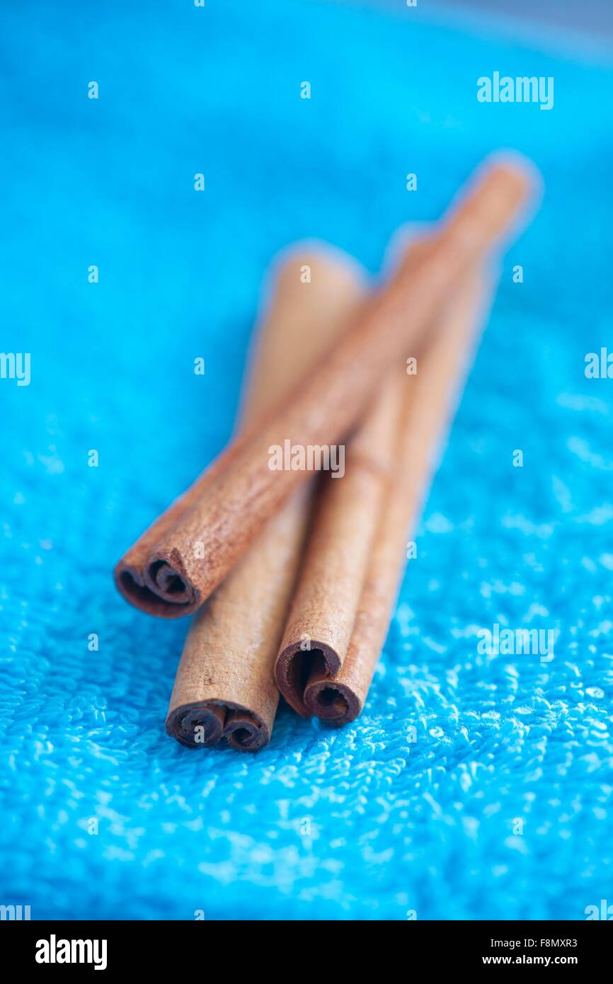 Cinnamon sticks on blue background Stock Photo - Alamy
