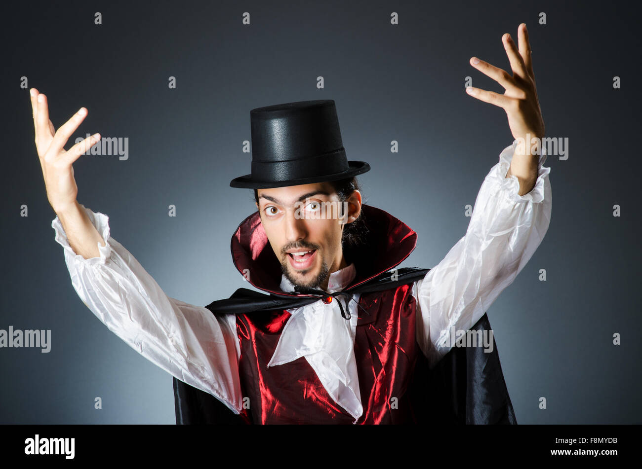 Magician doing tricks in dark room Stock Photo - Alamy