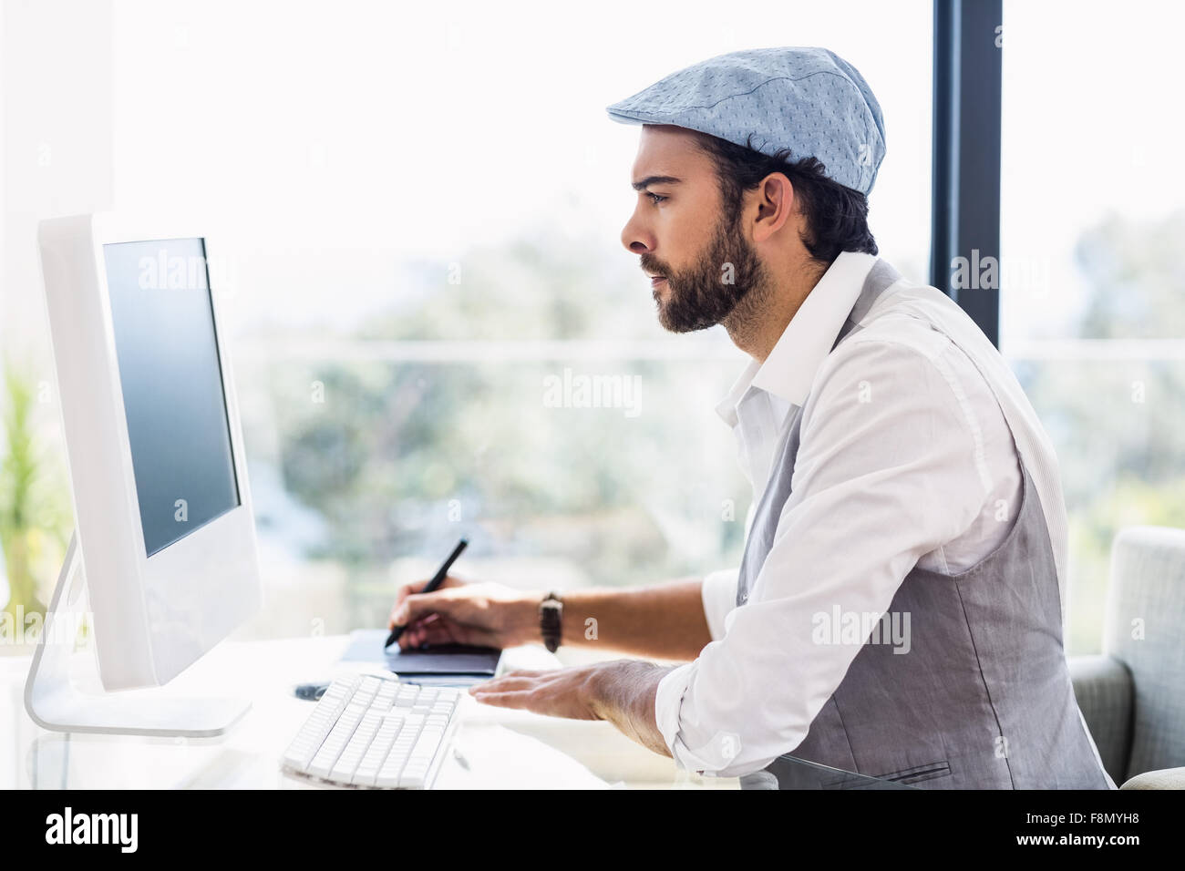 Side view of focused man working Stock Photo - Alamy
