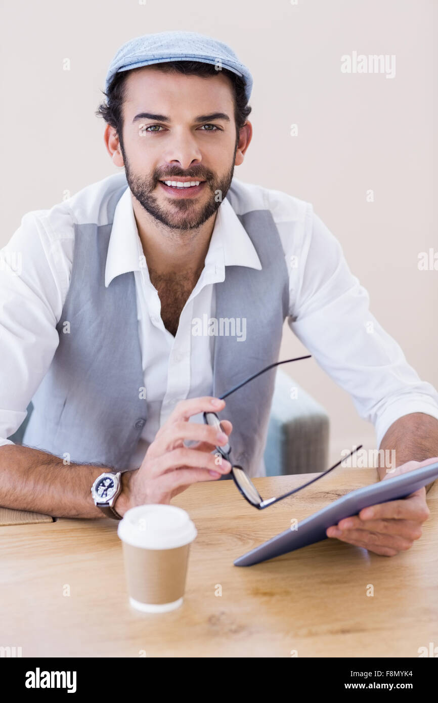 Portrait of smiling man holding tablet Stock Photo - Alamy
