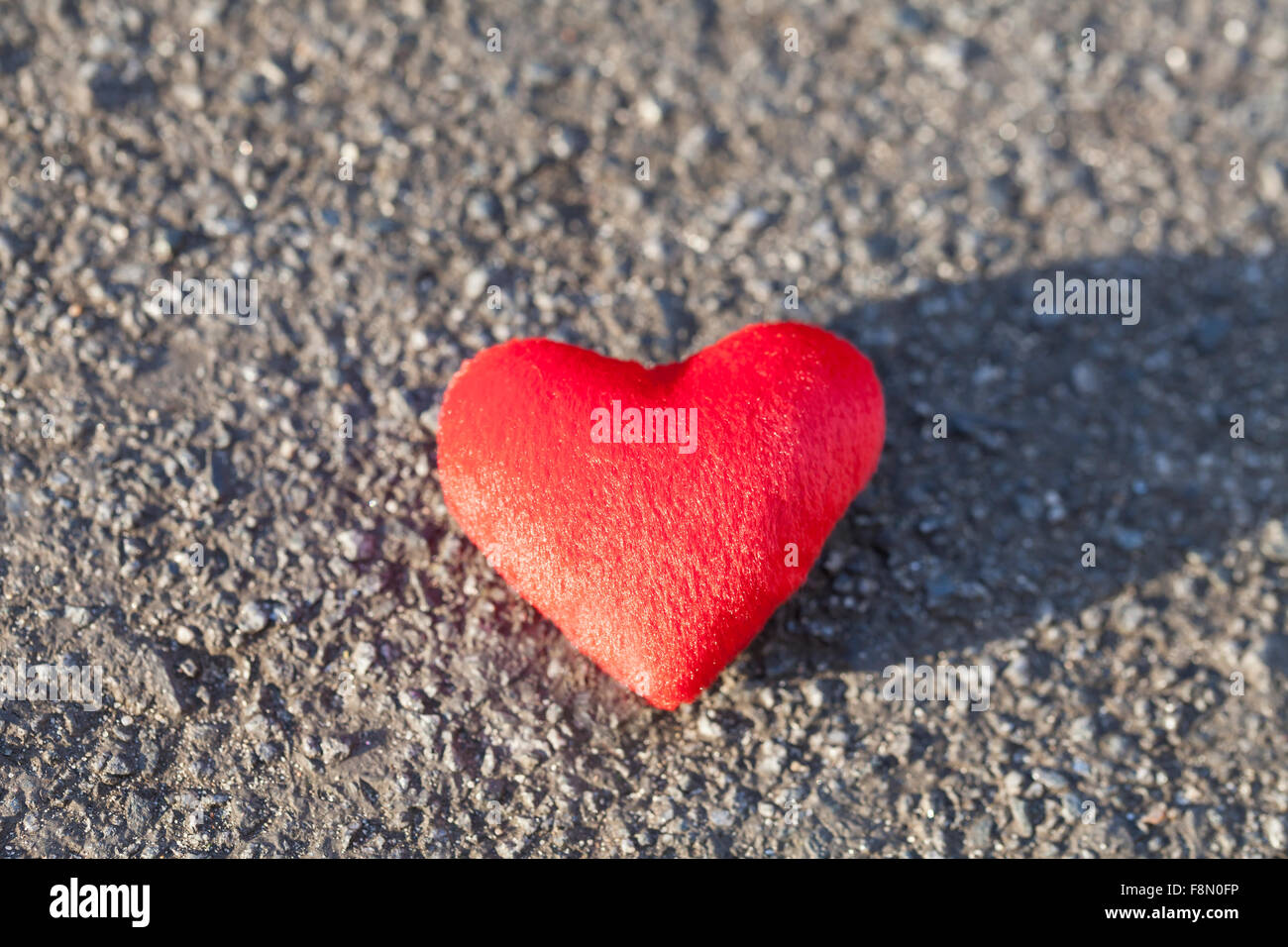 Red heart on asphalt Stock Photo - Alamy