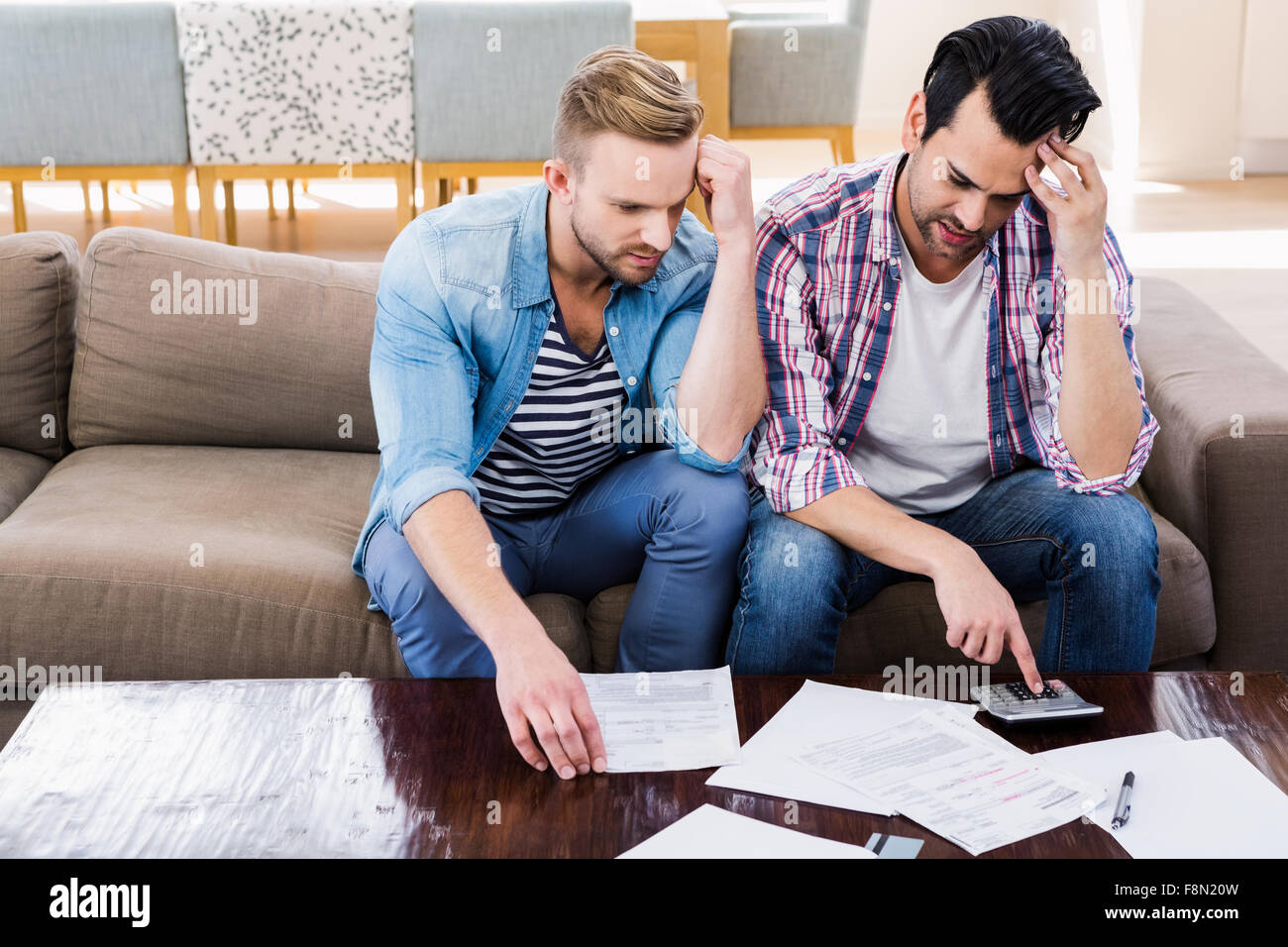 Gay couple worrying about their bills Stock Photo - Alamy