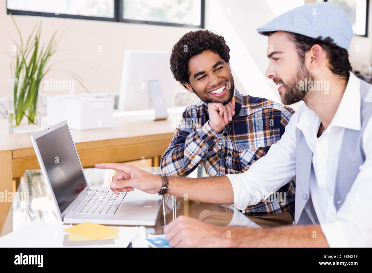 Happy gay couple using laptop Stock Photo - Alamy