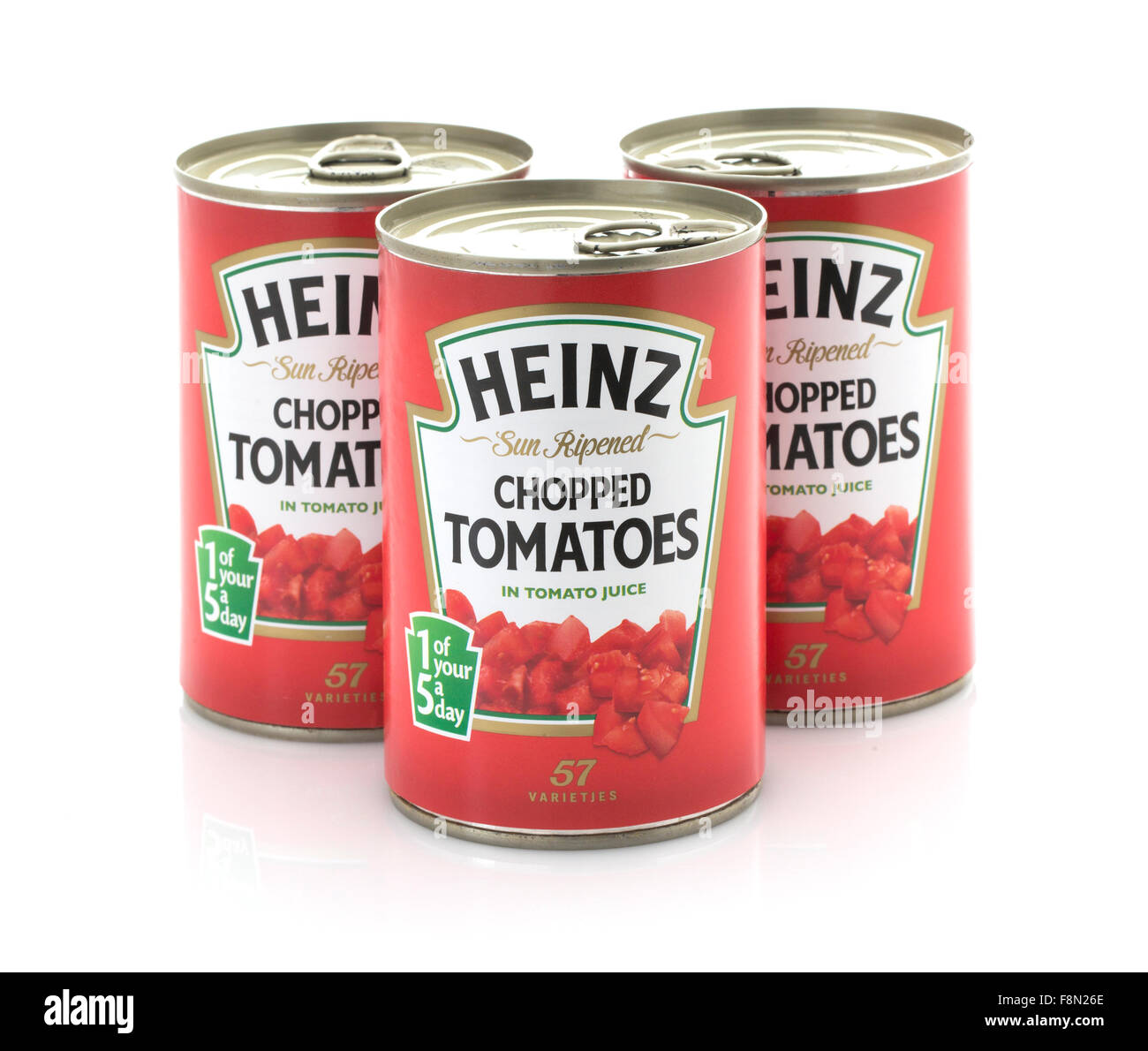 Three Tins of Heinz Chopped Tomatoes isolated on a white background ... Three Tins of Heinz Chopped Tomatoes isolated on a white background ...