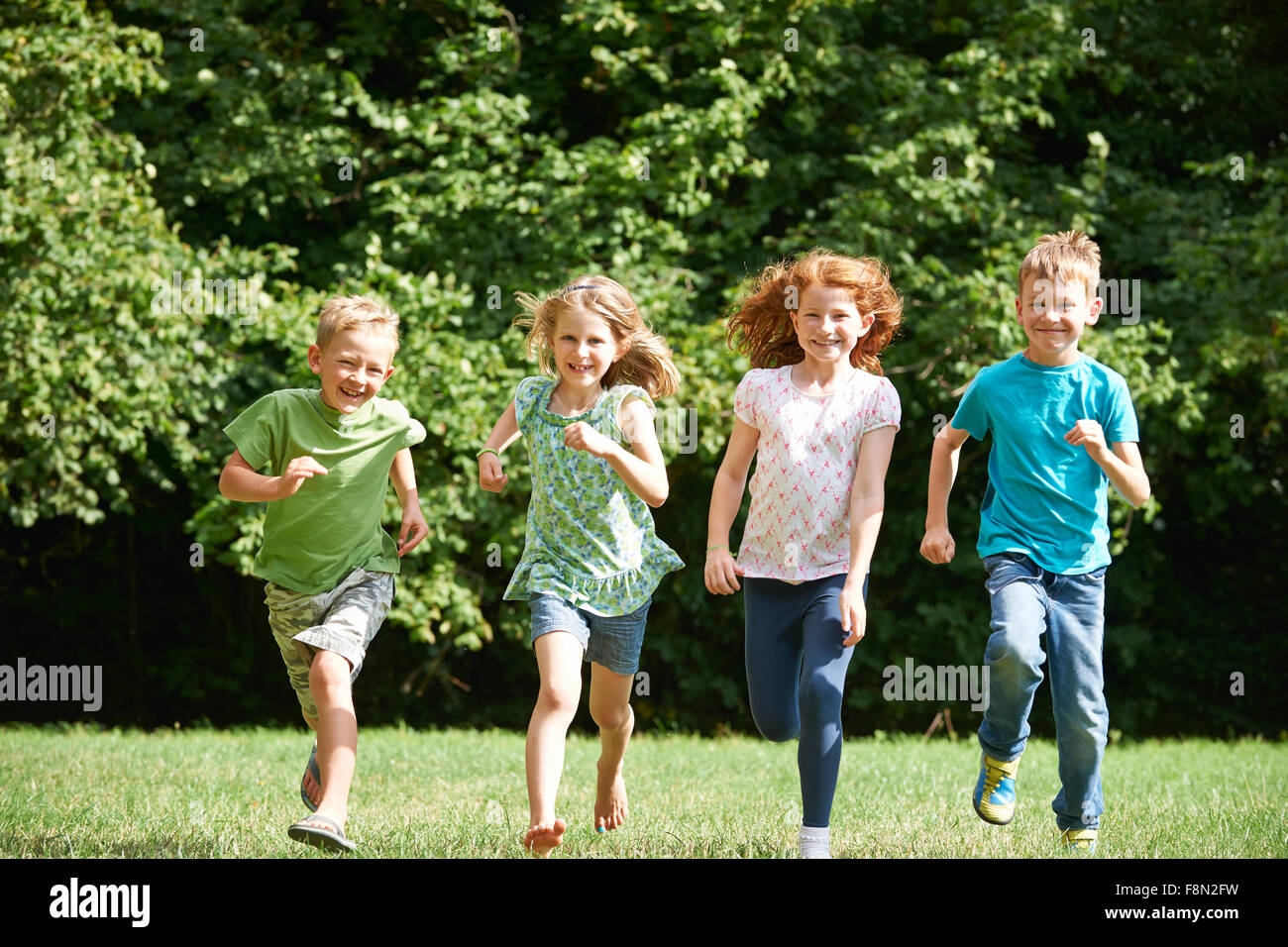 Group children running towards camera hi-res stock photography and ...