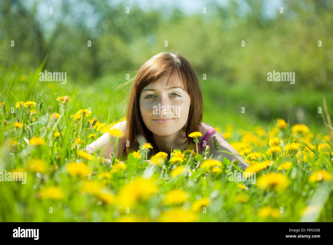 Happy freckle woman relaxing in park Stock Photo - Alamy