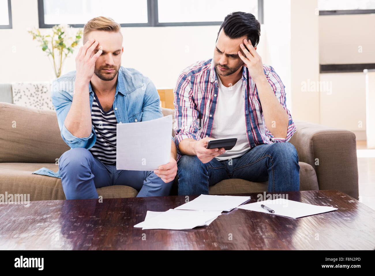 Gay couple worrying about their bills Stock Photo - Alamy