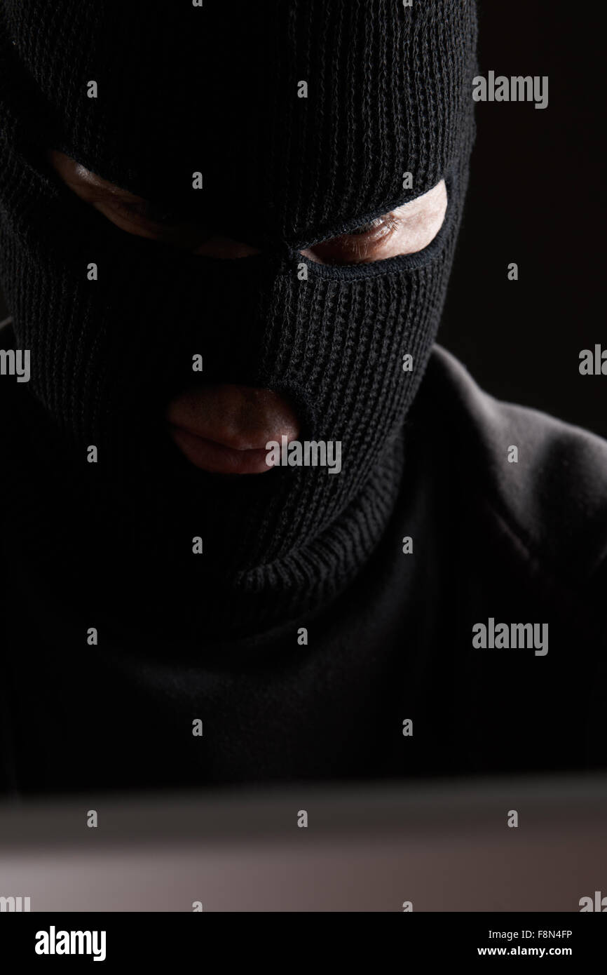 Masked Man Accessing Computer Data Stock Photo - Alamy
