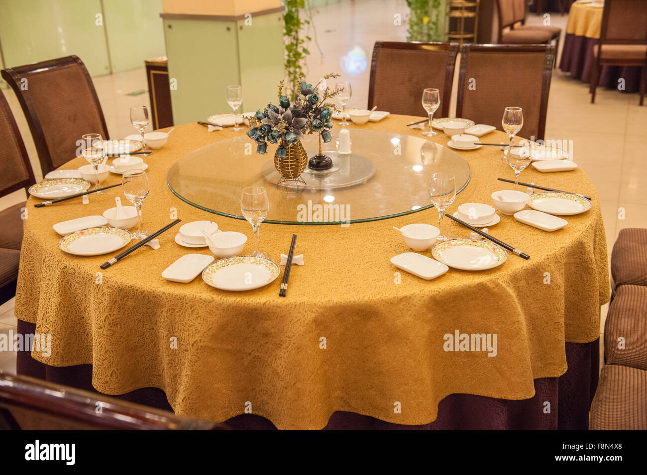 Large table with cutlery and plates in an Asian restaurant Stock Photo ...