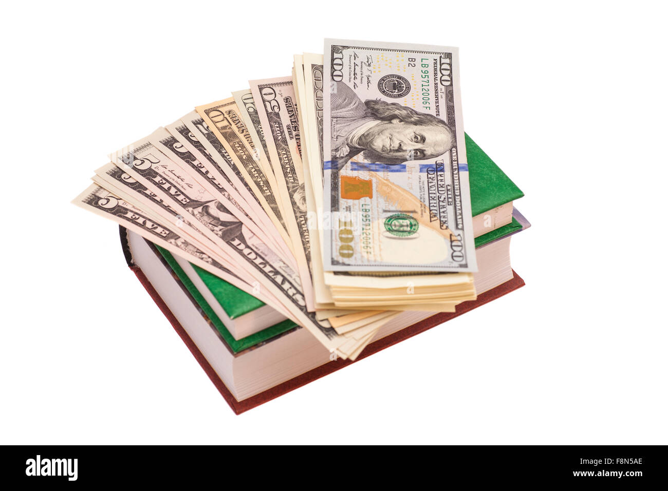 Dollars on the Books Stock Photo - Alamy