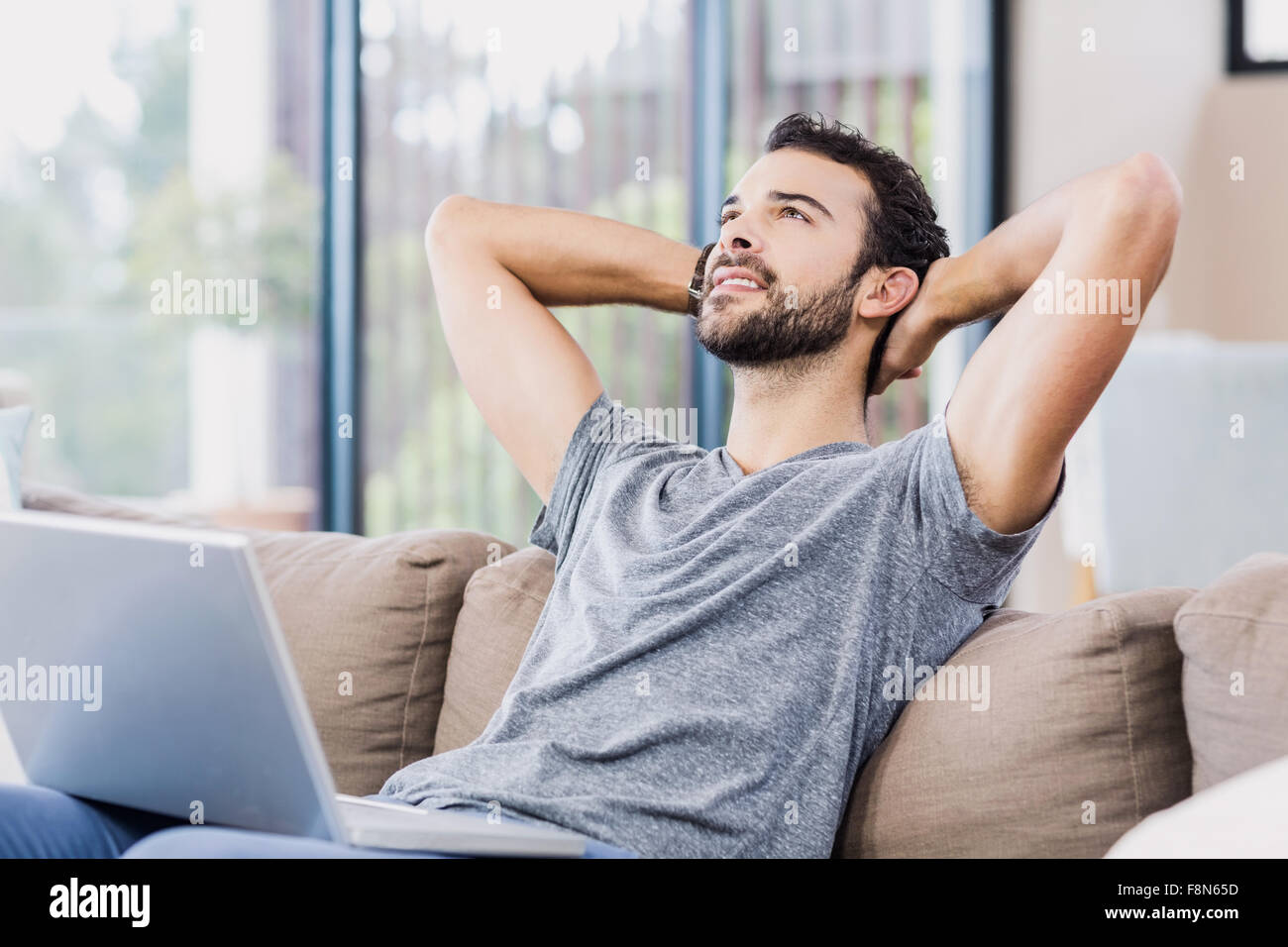 Handsome man relaxing on sofa Stock Photo - Alamy