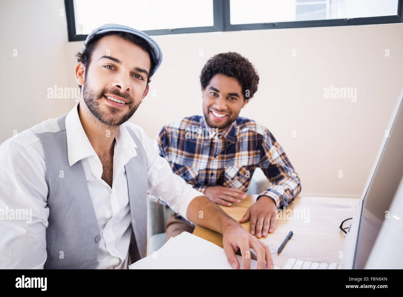 Smiling gay couple in office Stock Photo - Alamy