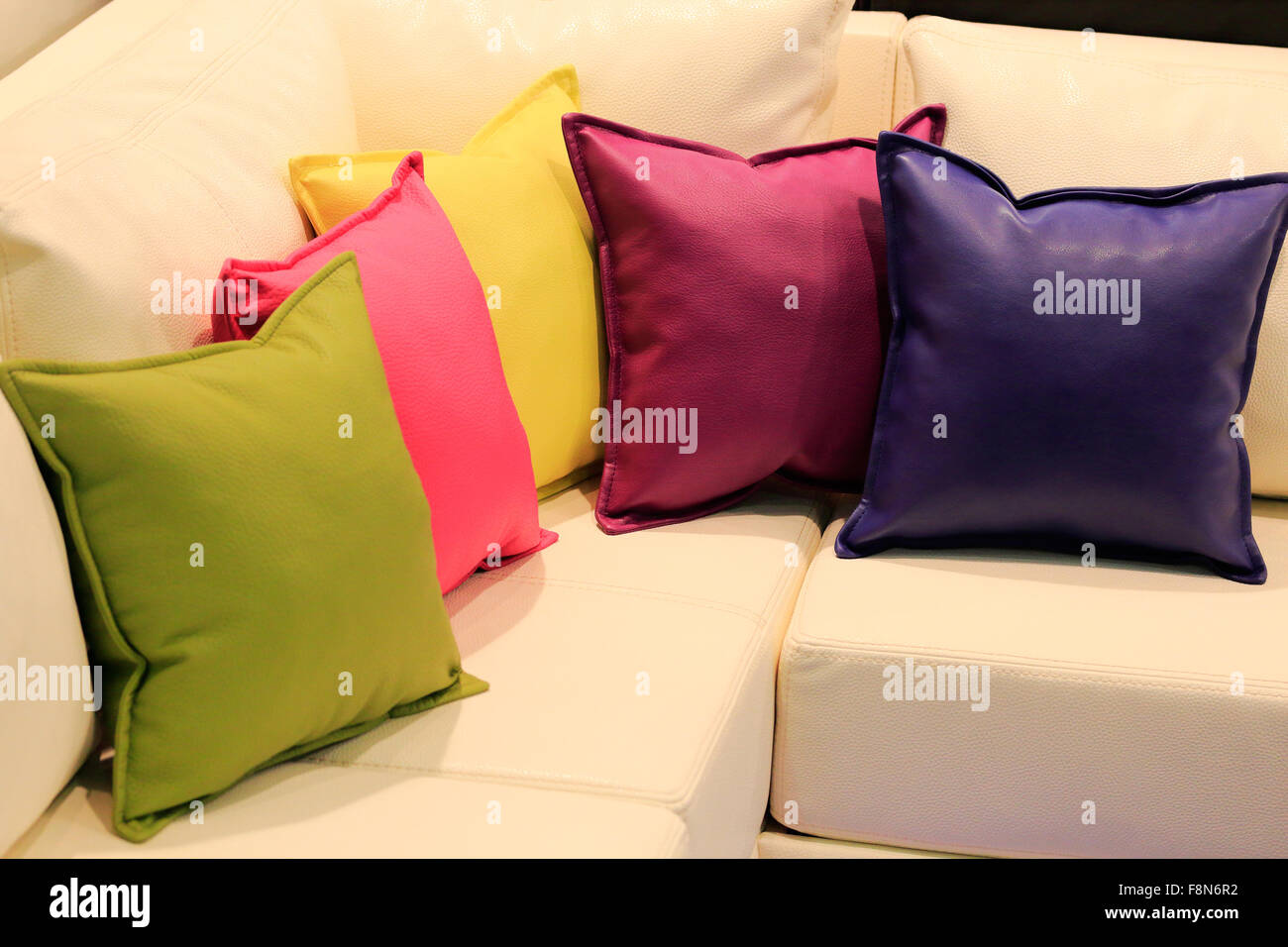 Pillows of different colors on the leather sofa Stock Photo - Alamy