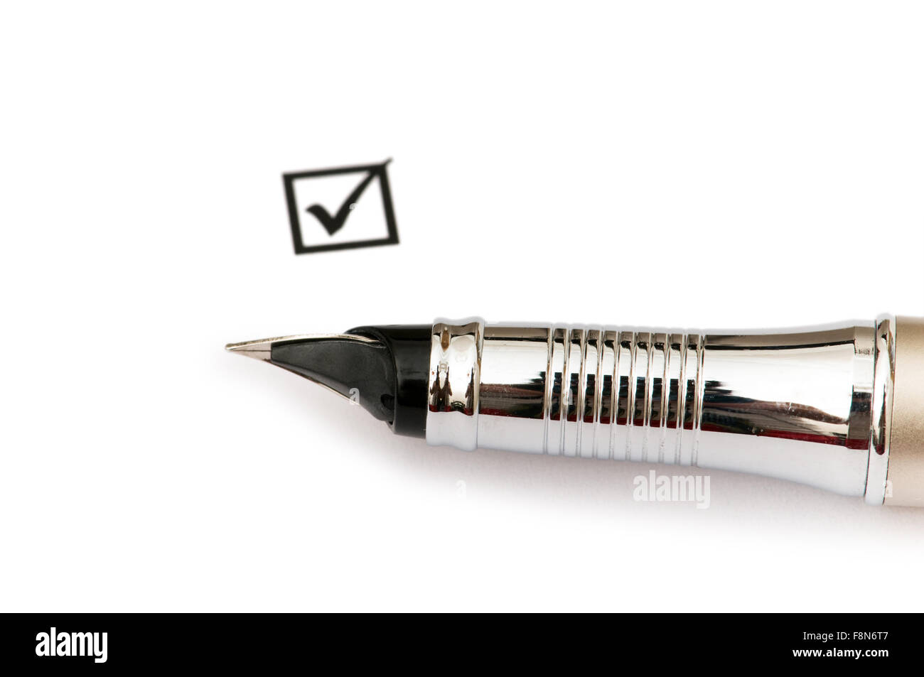 Pen and ticked tick box isolated on white Stock Photo - Alamy
