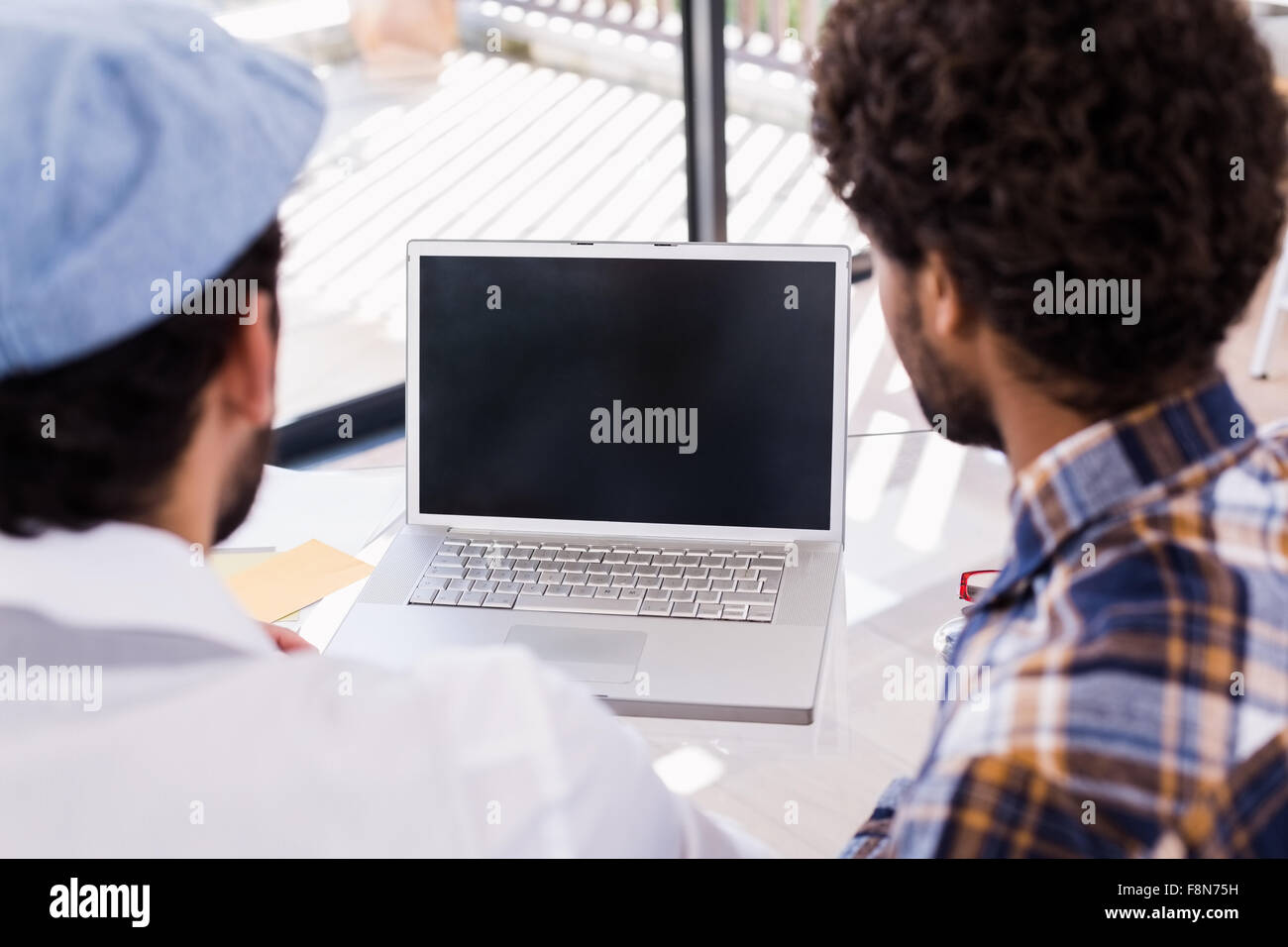 Gay couple using laptop Stock Photo - Alamy