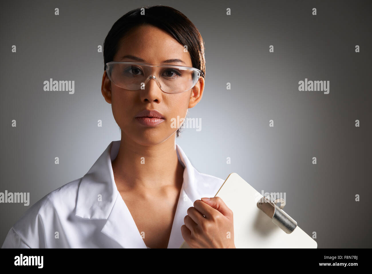 Female Scientist Writing On Clipboard Stock Photo - Alamy
