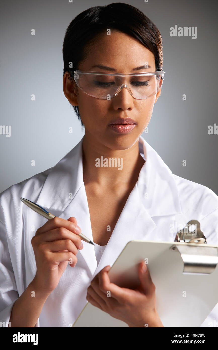 Female Scientist Writing On Clipboard Stock Photo - Alamy