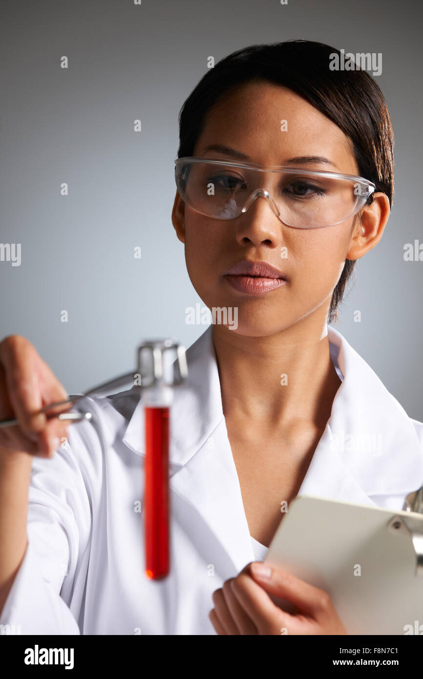 Female Scientist Examines Test Tubes Stock Photo - Alamy