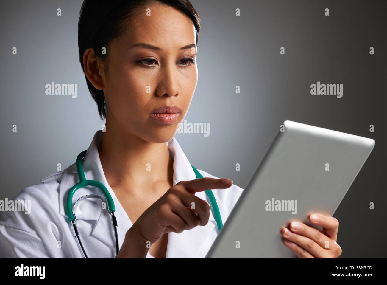 Studio Shot Of Doctor Using Digital Tablet Stock Photo - Alamy
